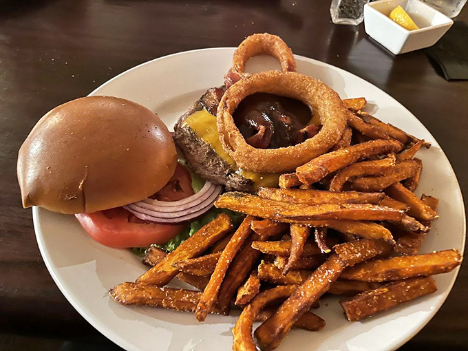 This isn't just any burger – it's a hand-formed patty topped with melted cheese and served with sweet potato fries that'll ruin you for all others.