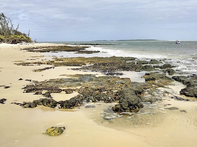 Sunlight dances across rocky outcroppings, revealing the fascinating geological diversity that makes this beach uniquely captivating.