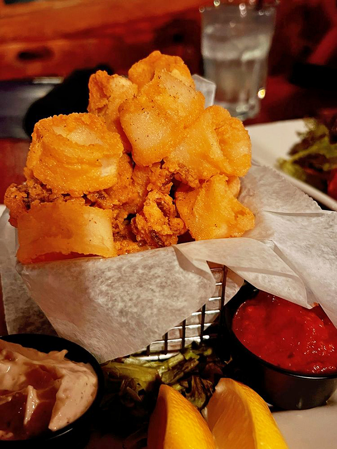 Crispy calamari that shatters like delicate glass, revealing tender rings within &ndash; the ocean's most misunderstood creature transformed into addictive bites.