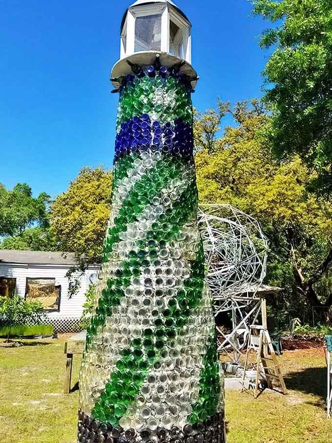 Stripes of green, blue, and clear bottles create a hypnotic pattern that changes throughout the day as the sun shifts position.