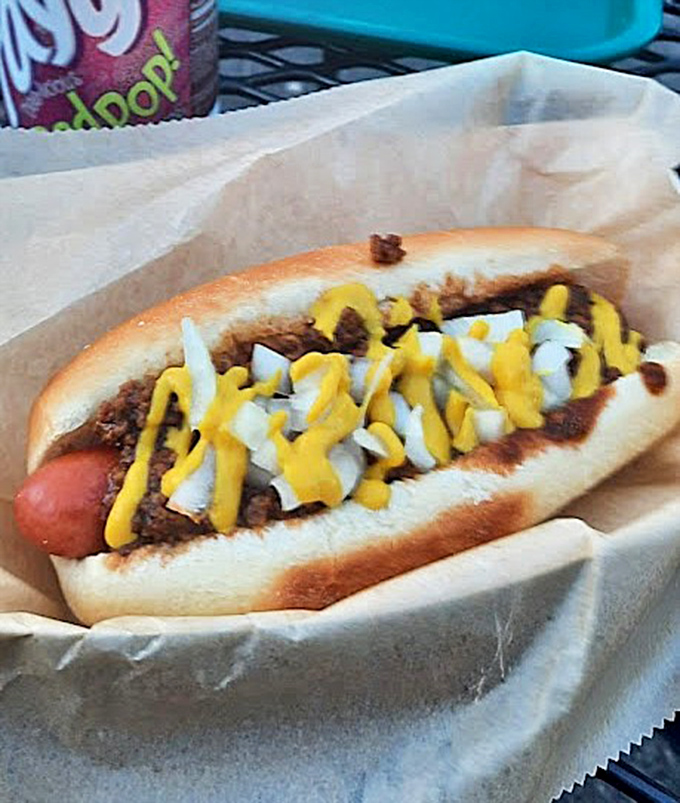 The classic arcade fuel gets the respect it deserves &ndash; a snappy dog adorned with chili, onions, and mustard that would make Pac-Man change direction.