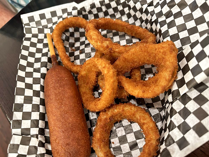 Golden-brown perfection &ndash; a classic corn dog and onion rings that transport you straight to childhood fair days.