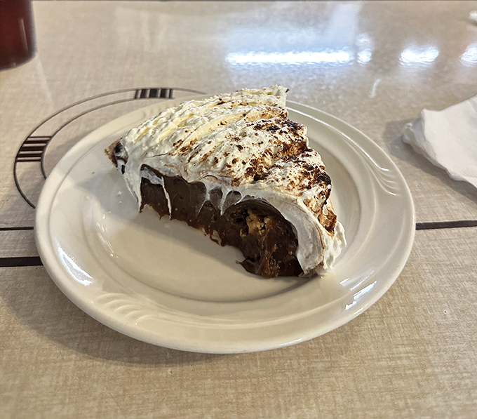 Another angle of Wheeler's famous pie reveals its perfect layers &ndash; graham cracker crust, chocolate filling, and peanut butter cream that dreams are made of.
