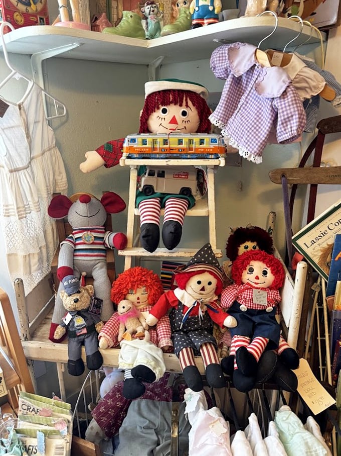 Raggedy Ann and friends sit patiently on their shelf, their well-loved fabric faces telling stories of bedtime snuggles from decades past.