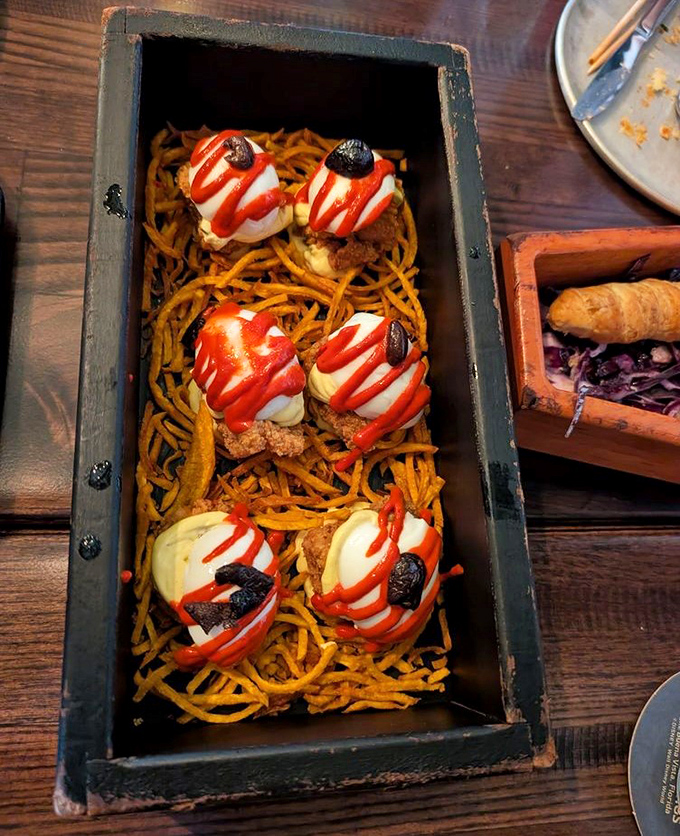 "Zombie Eye Bites" stare back from their nest of crispy noodles&mdash;deviled eggs that took a detour through the Temple of Doom.