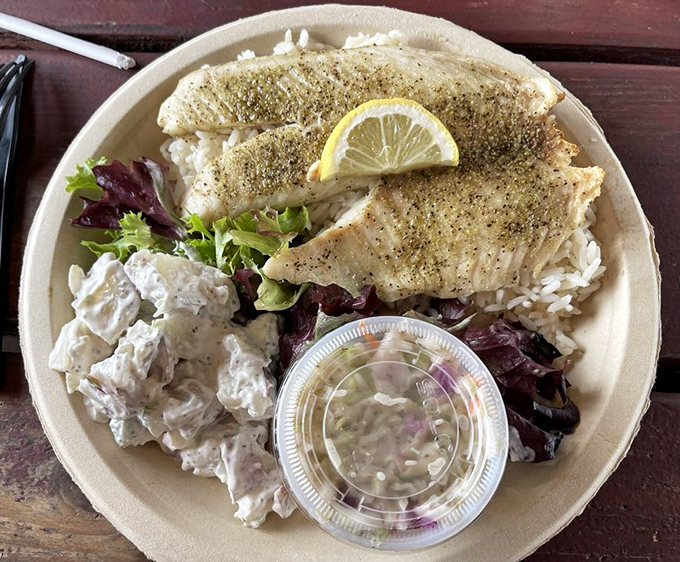 Perfectly grilled fish resting on a bed of rice, simple yet sublime &ndash; proof that seafood needs little embellishment when it's this fresh.