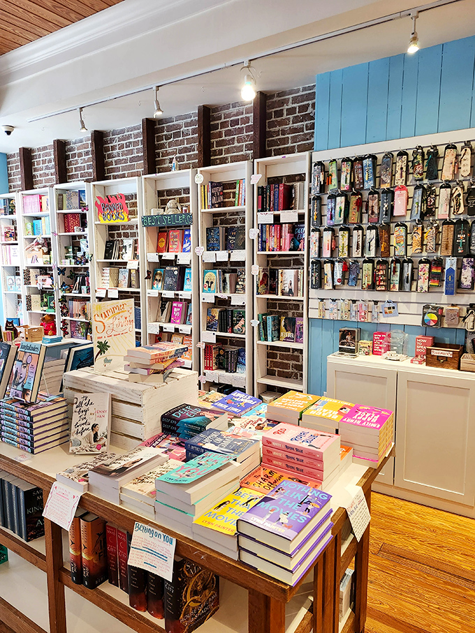 White shelves pop against exposed brick walls, creating a contemporary yet timeless atmosphere where bestsellers mingle comfortably with classic literature.