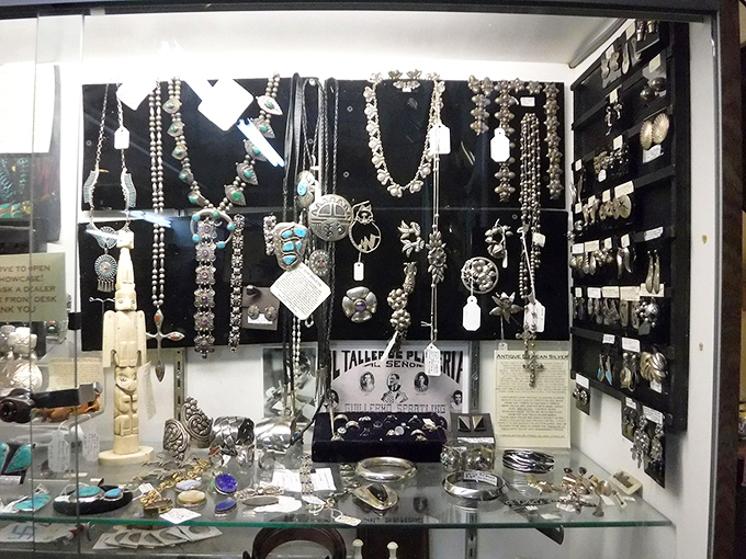 Silver, turquoise, and vintage costume pieces sparkle behind glass &ndash; each necklace and brooch once adorned someone's special occasion outfit.