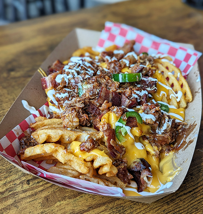 These loaded fries aren't messing around &ndash; piled high with pulled pork, cheese sauce, and green onions for maximum indulgence.