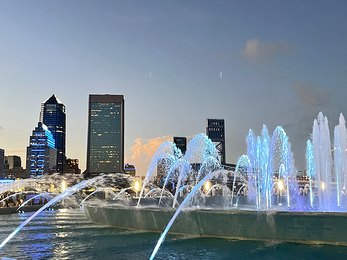 Dusk settles over Jacksonville as Friendship Fountain begins its evening performance, the water jets silhouetted against the twilight sky.
