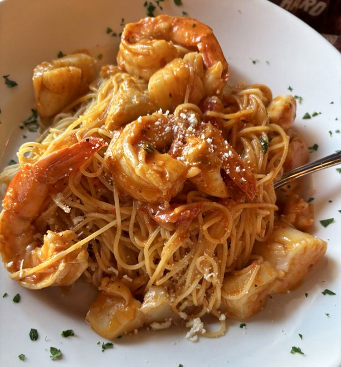 Seafood and pasta perform a perfect duet in this Pescatore dish, where plump shrimp and tender scallops mingle with al dente spaghetti.