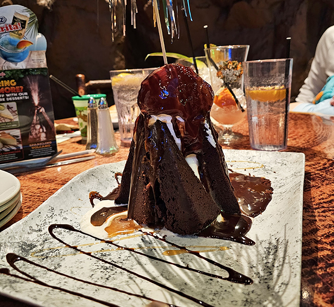The legendary Volcano dessert arrives with chocolate "lava" flowing dramatically, causing nearby diners to experience immediate dessert envy.