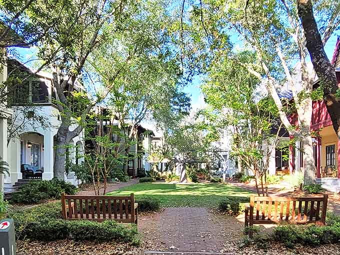 This tranquil residential park offers a shady respite from beach adventures, where wooden benches invite contemplation under a canopy of mature trees.