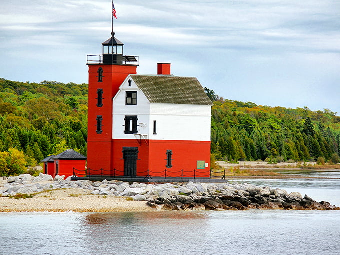 Round Island Lighthouse stands as a cheerful maritime sentinel, its red and white fa&ccedil;ade a beacon for boats navigating the straits.
