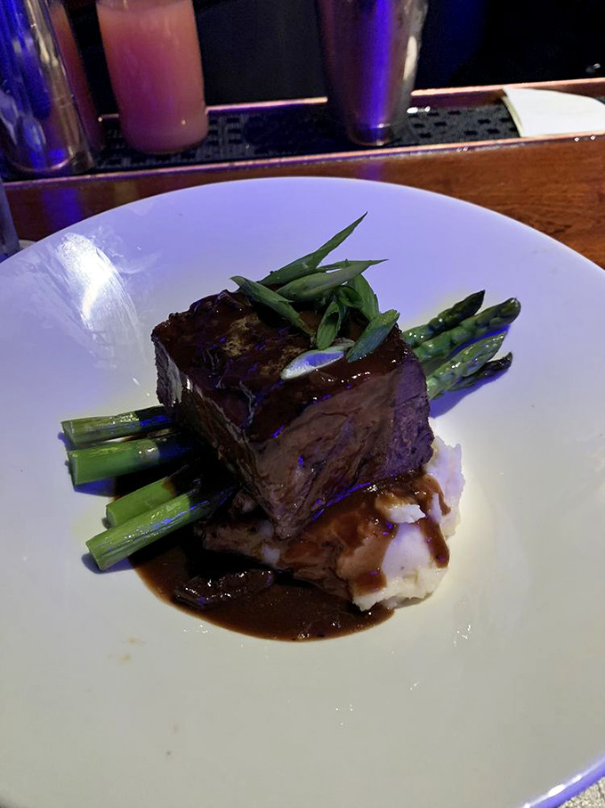 This isn't just dinner; it's architecture&mdash;a perfect stack of fork-tender beef atop vibrant asparagus spears, all swimming in a reduction that deserves its own patent.