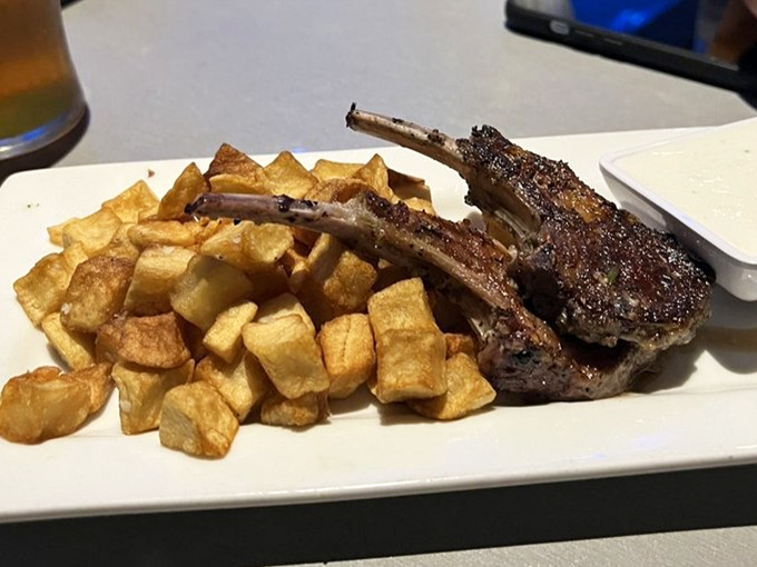 Grilled lamb chops with golden potatoes that might make you forget you're dining in an aquarium&mdash;until a hammerhead swims by to remind you.
