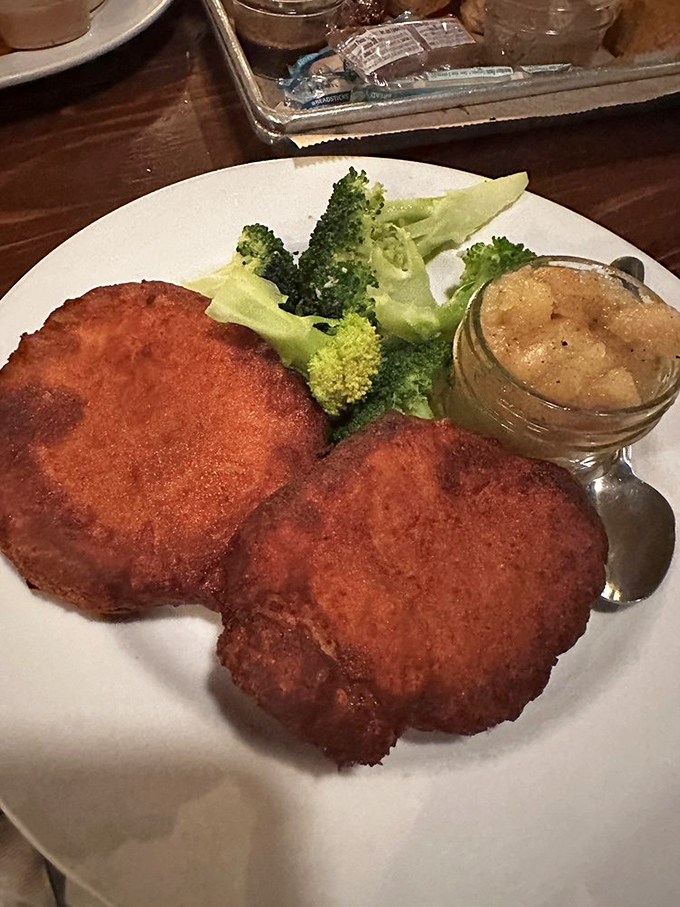 The house specialty chop arrives golden-brown with fresh broccoli and homemade applesauce &ndash; comfort food elevated to an art form.