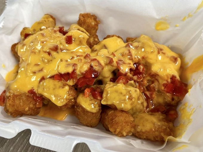 Tater tots living their best life under a blanket of spicy cheese &ndash; the kind of comfort food that makes you want to hug the chef.