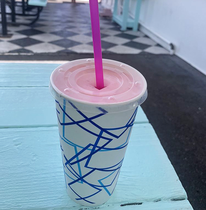 This strawberry milkshake isn't playing games—thick enough to require serious straw commitment and pink enough to make flamingos jealous of its vibrant hue.