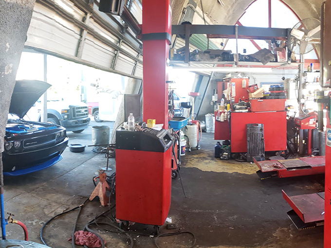 Inside the dinosaur's belly, it's all business&mdash;red tool chests and vehicle lifts transform fantasy into functional workspace.