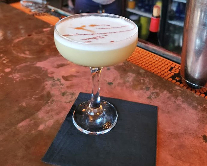 The Whiskey Sour Flip's frothy top tells you this isn't your average cocktail &ndash; it's liquid artistry with a silky finish.