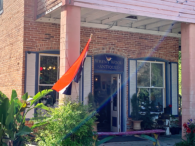 Wren Wood Antiques offers carefully curated collections beneath a cheerful orange flag, a beacon for discerning vintage enthusiasts.