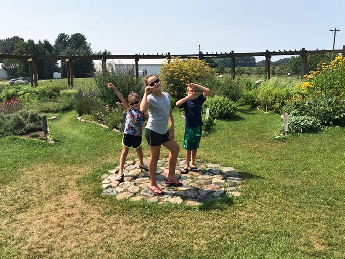 Visitors striking playful poses at the heart of the labyrinth &ndash; finding your center has never looked so fun!