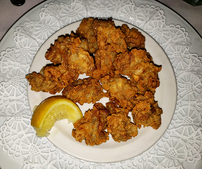 Crispy cornmeal coating shatters with each bite, revealing plump, juicy oyster meat within. This is seafood alchemy at its finest.
