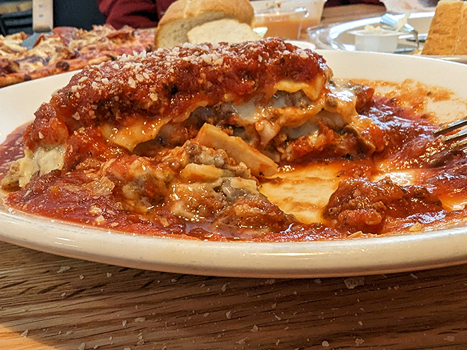 Hearty Baked Lasagna: Each forkful reveals architectural perfection &ndash; sturdy pasta foundations supporting creamy cheese and savory meat in perfect structural harmony.