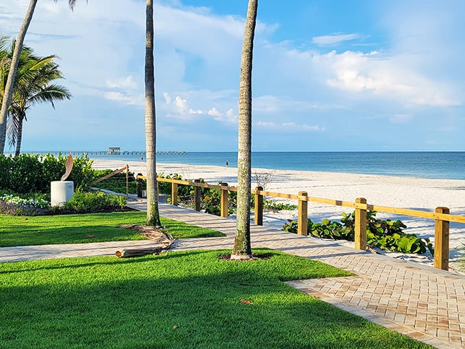 A peaceful park bench invites contemplation beside a serene lake, offering a quiet moment away from Naples' more bustling attractions.