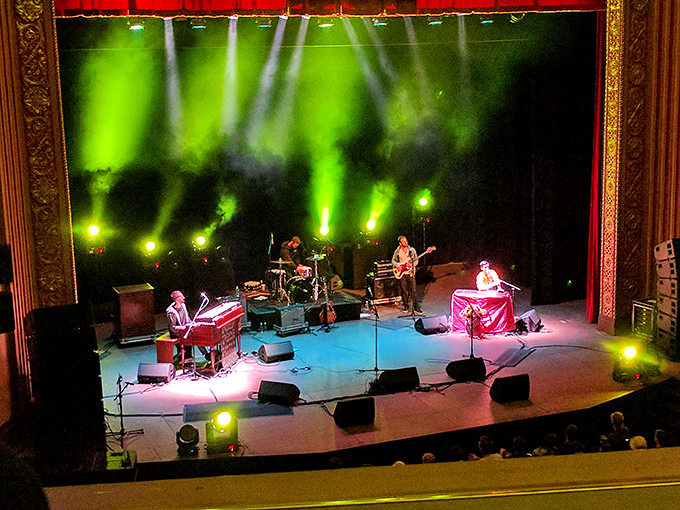 Musicians transform the historic stage into a concert venue, proving this grand dame of theaters can still rock when called upon.