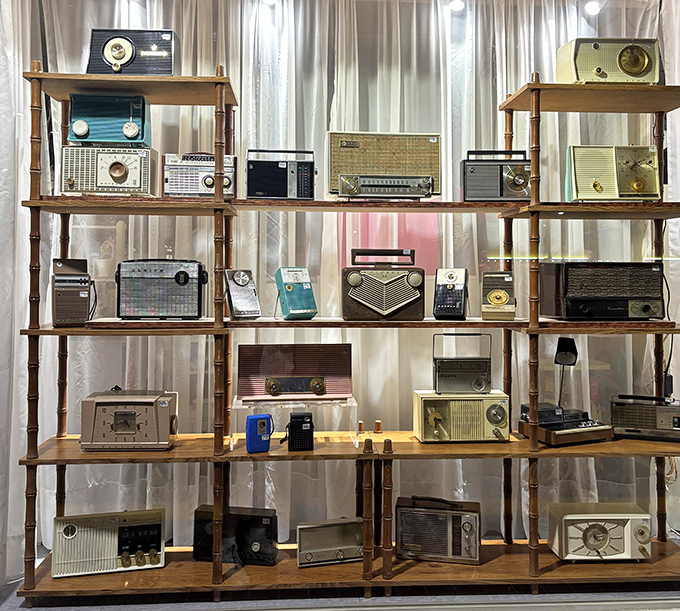 A symphony of vintage radios stands silent but proud, from an era when electronics were furniture and "wireless" meant something completely different.