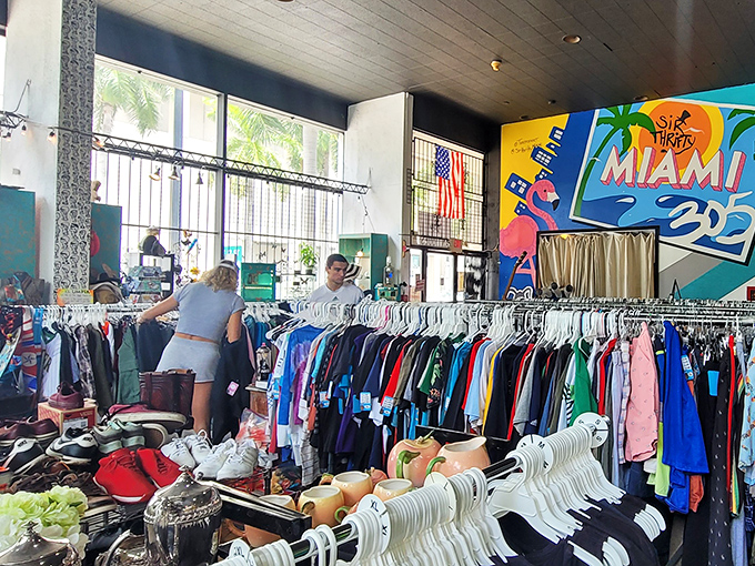 Treasure hunters in their natural habitat &ndash; shoppers navigate the colorful jungle of vintage finds beneath Miami's vibrant wall art.