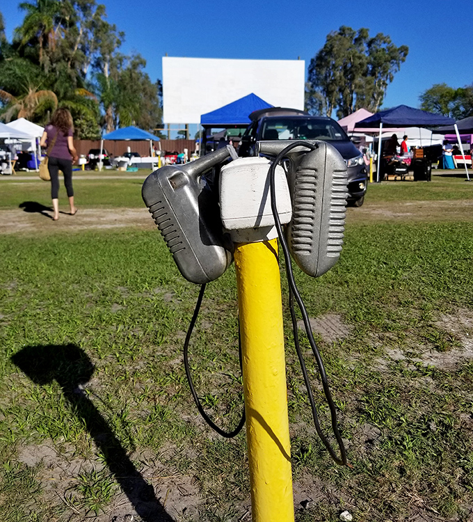 The yellow speaker post stands sentinel, a charming relic from cinema's golden age now serving as decoration.
