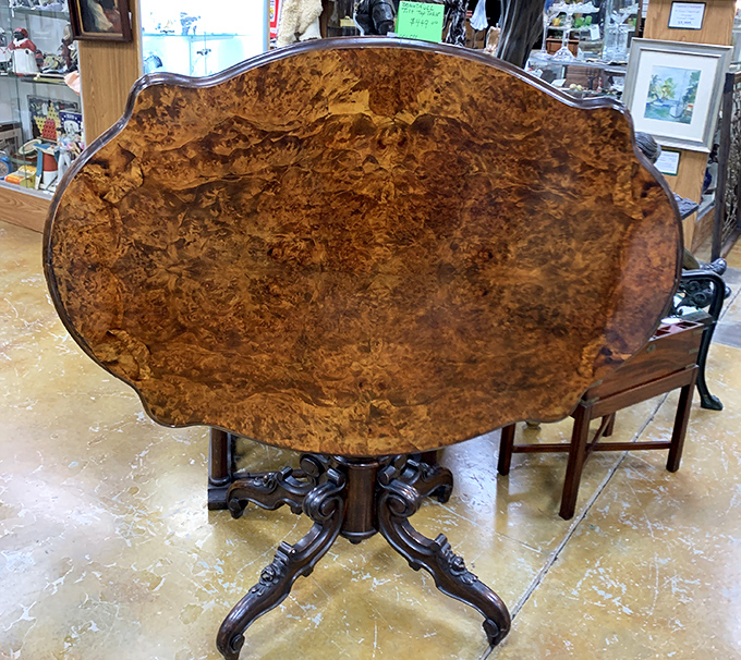 This exquisite burled wood tilt-top table showcases craftsmanship from an era when furniture wasn't just functional, but family heirlooms in the making.