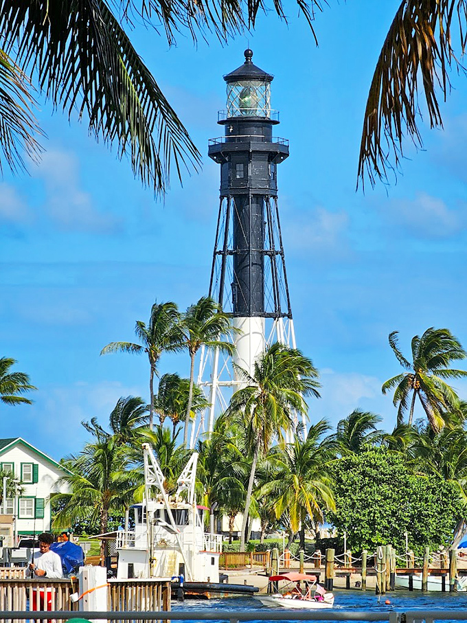 Hillsboro Inlet's distinctive black and white striped lighthouse stands like a nautical exclamation point against Florida's perfect blue sky.