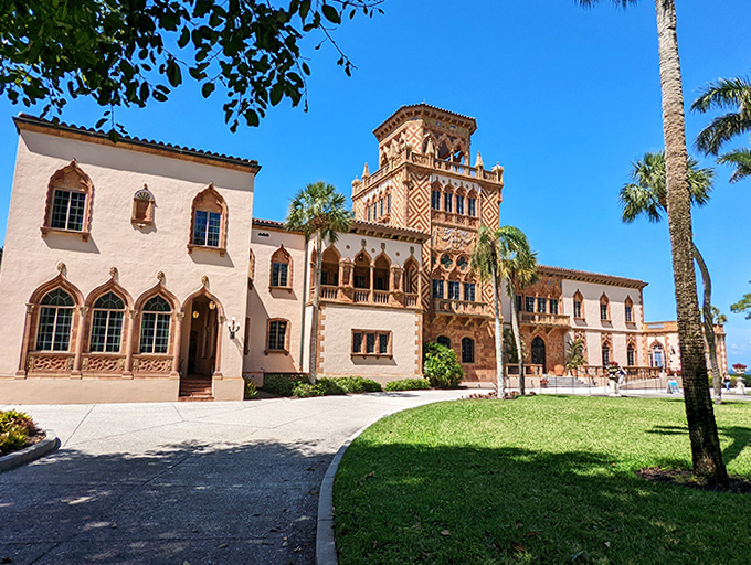 This majestic mansion showcases elaborate Gothic arches and colorful details, a Mediterranean fantasy brought to life.