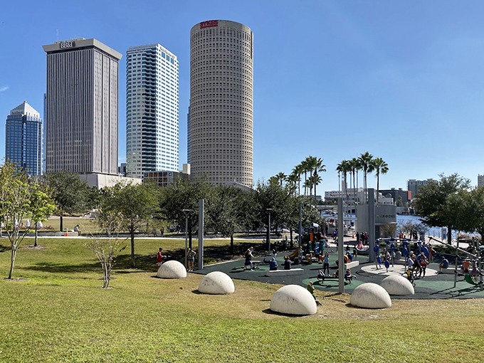 Tampa's skyline frames the Curtis Hixon Park fountain, where office buildings watch over water-loving locals enjoying their downtown oasis.