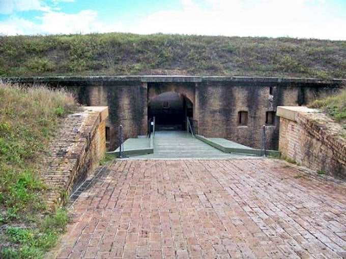 The fort's interior passageway showcases the remarkable craftsmanship of 19th-century military construction, with brick arches stretching into the distance.