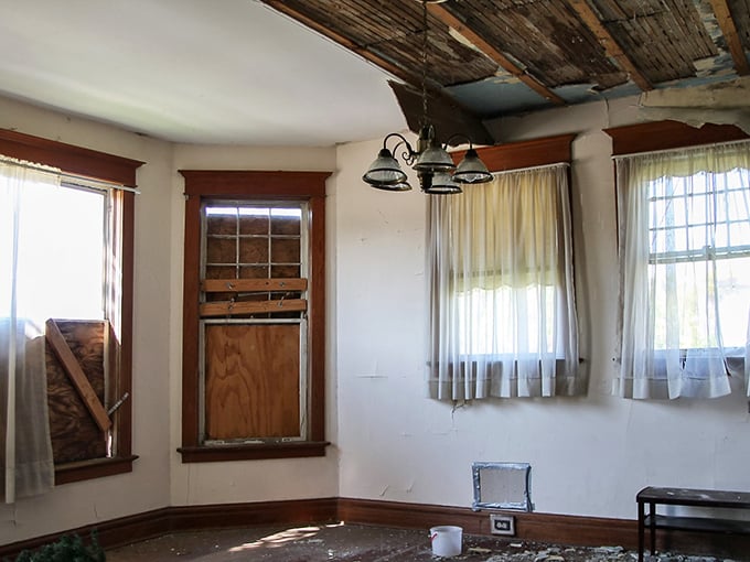 Sunlight streams through curtains that still hang with surprising grace, illuminating a room where time stopped decades ago.