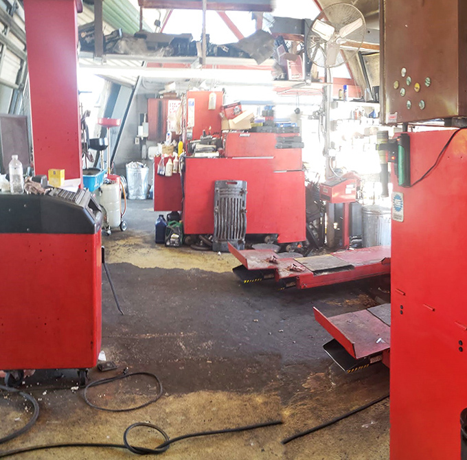 Mechanics navigate the curved interior with practiced ease, having adapted their craft to this most unusual of workspaces.