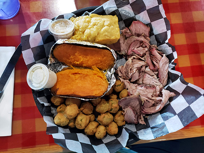 A carnivore's dream landscape – tender pulled pork, sweet potatoes, and cornbread. This isn't just a meal; it's a Southern comfort expedition on a plate.