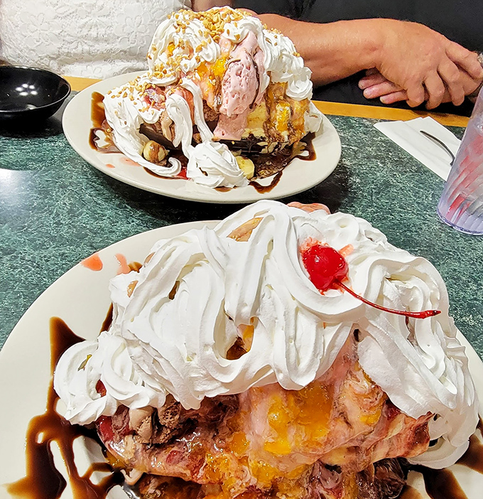 The banana split arrives like royalty &ndash; cherries perched atop whipped cream mountains, challenging even the most determined sweet tooth to reach the summit.