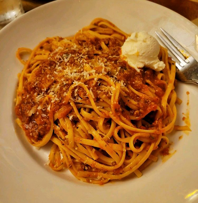 The Bolognese sauce clings lovingly to each strand of pasta, a rich meat sauce that's clearly been simmering since before you even thought about dinner.