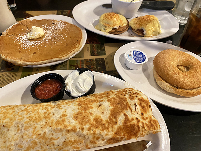 A breakfast spread that would make champions weep – pancakes, eggs benedict, and that burrito holding court like the star it is.
