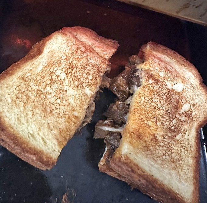 Brisket Melt: Melted cheese embraces tender brisket in a warm hug that will make your taste buds weep with joy.