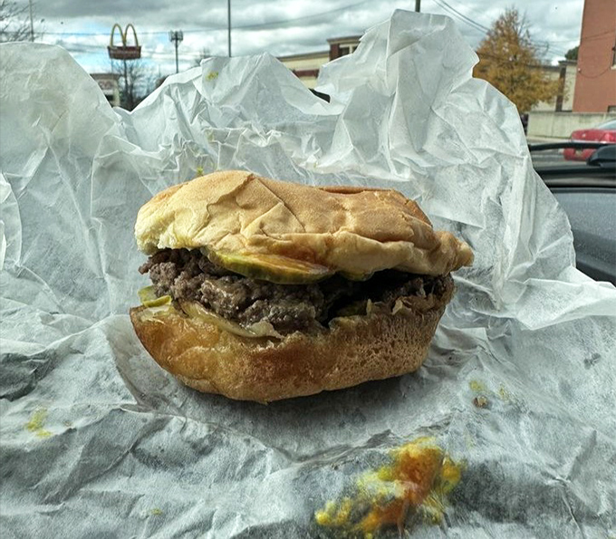 The classic Telway burger sits unpretentiously on its wrapper, a palm-sized promise of satisfaction that locals order by the bagful.