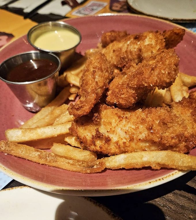 Crispy chicken tenders with dipping sauces – simple perfection that proves sometimes the best rock anthems don't need complicated arrangements.