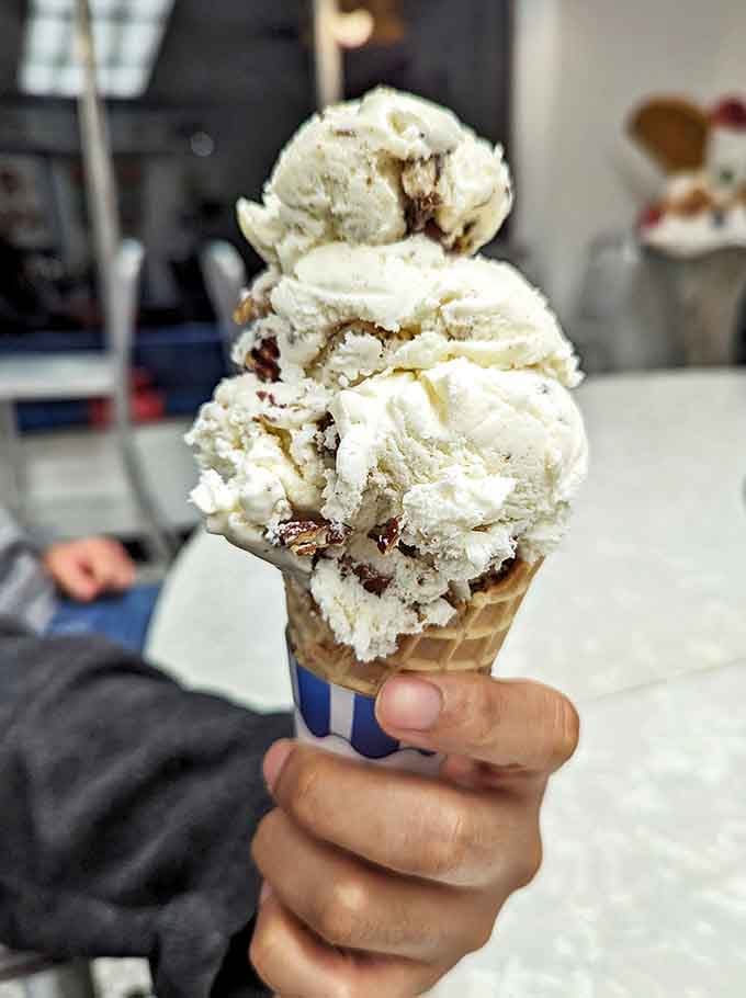 Three perfect scoops of cookie dough ice cream stand tall in this waffle cone, demonstrating the proper ice cream-to-cone ratio that mathematicians have studied for generations.