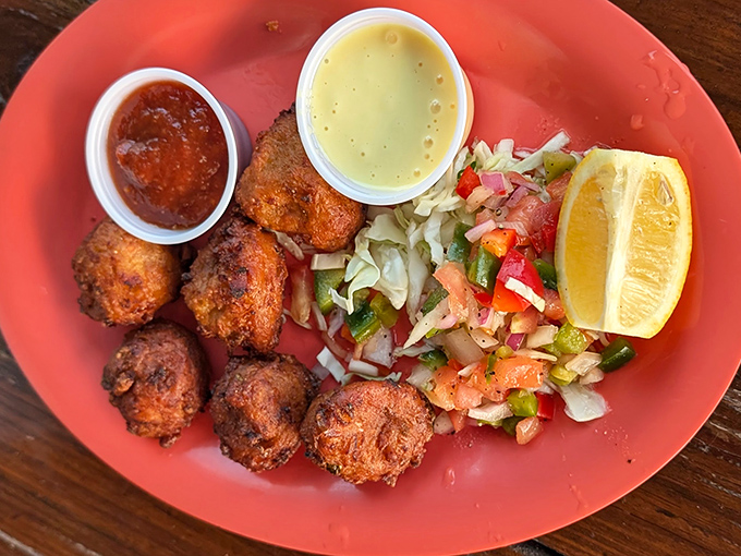 Golden-brown conch fritters &ndash; crunchy outside, tender inside &ndash; served with tangy dipping sauce and a side of Keys history.